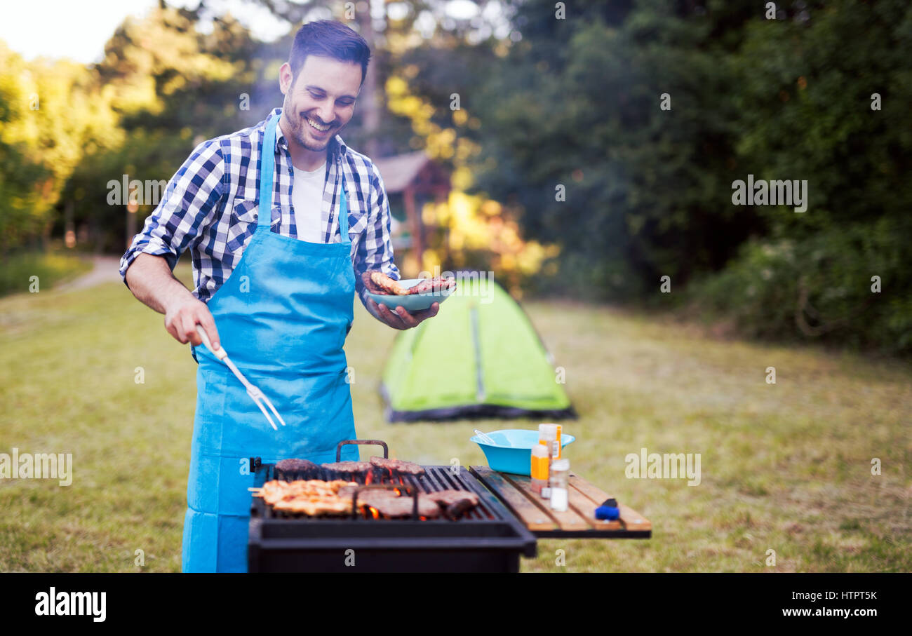 Happy male grilling bbq meat outdoor in nature Stock Photo - Alamy