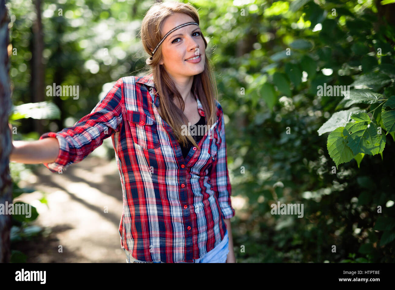Portrait of pretty backpacker woman hiking in forest Stock Photo - Alamy