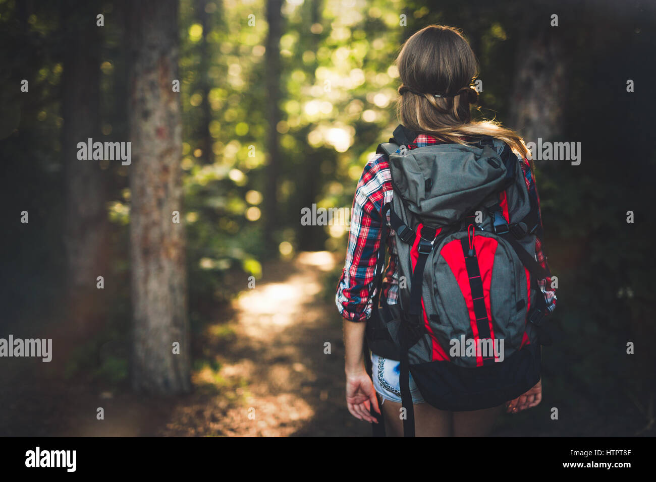 Portrait of pretty backpacker woman hiking in forest Stock Photo - Alamy