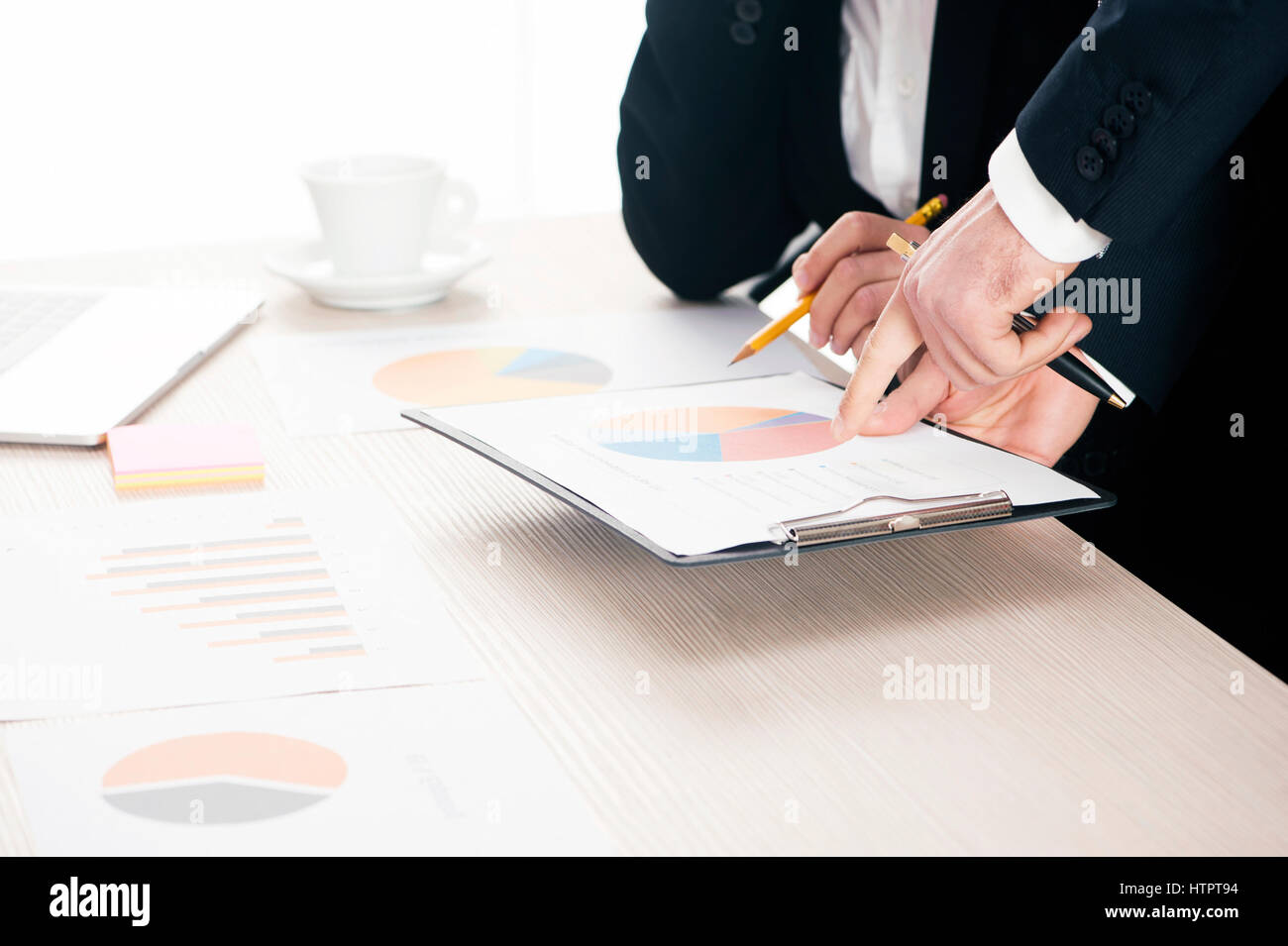 Business people working at meeting with charts Stock Photo - Alamy