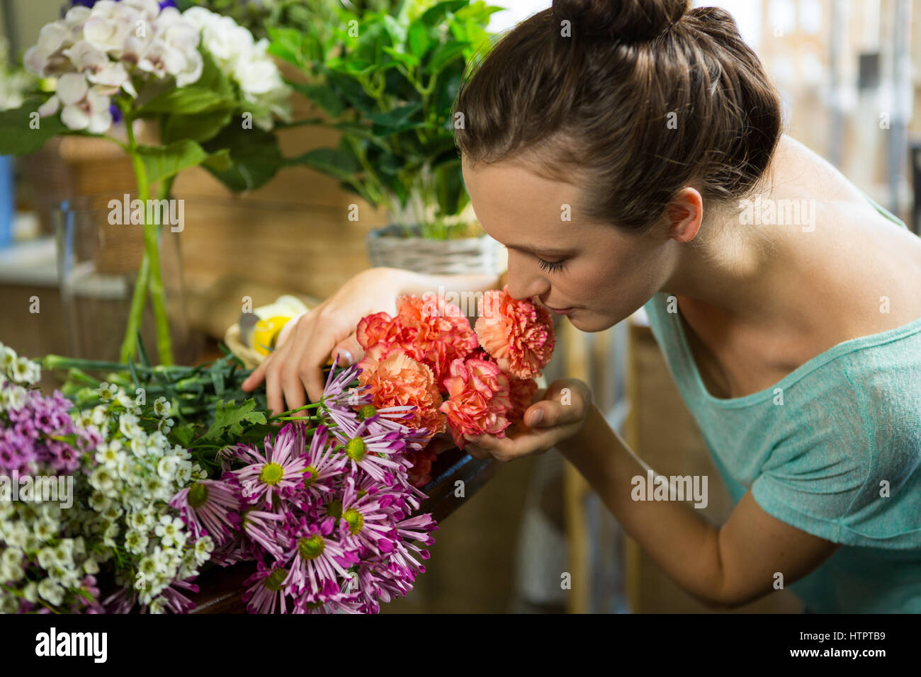 Woman smelling pink flower hi-res stock photography and images - Alamy