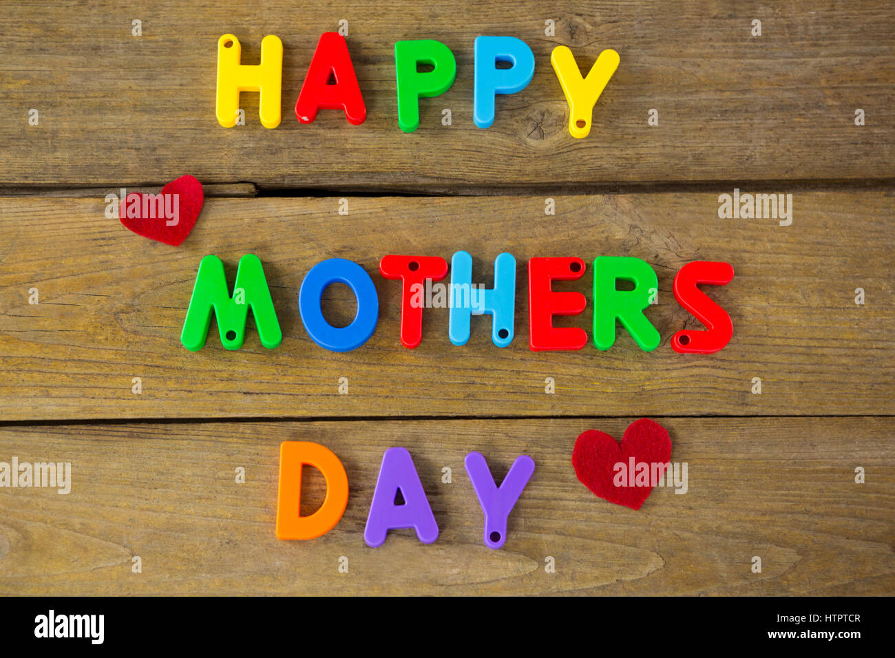 Alphabets displaying happy mothers day on wooden plank Stock Photo - Alamy
