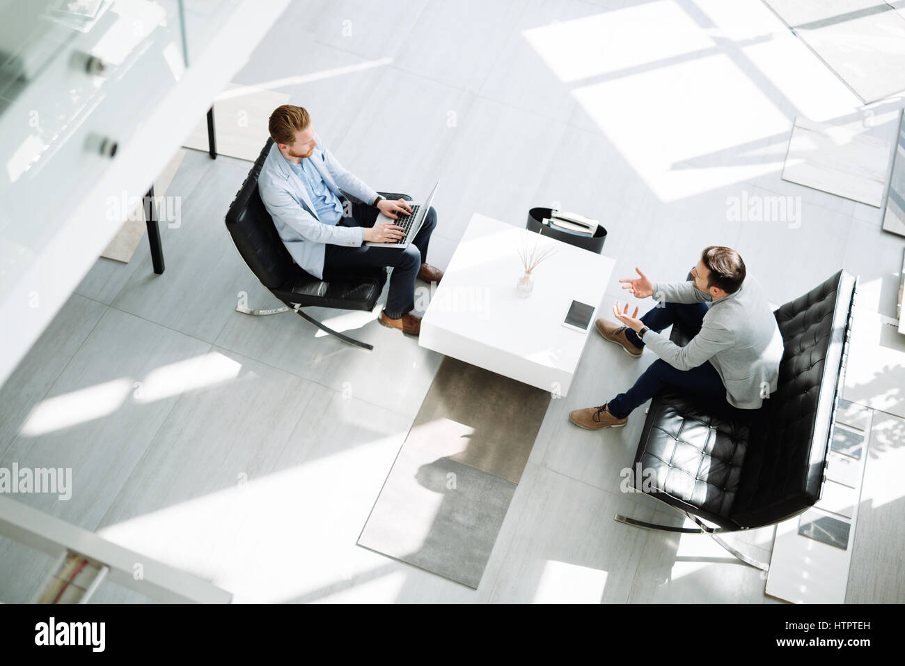 Business meeting in lobby by two businessmen Stock Photo - Alamy