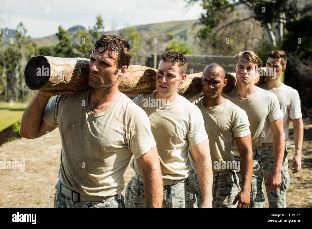 Soldiers carrying a tree log in boot camp Stock Photo - Alamy