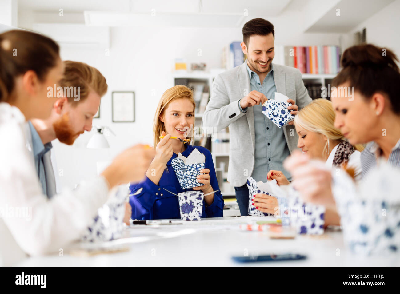 Business people eating meals in office Stock Photo - Alamy
