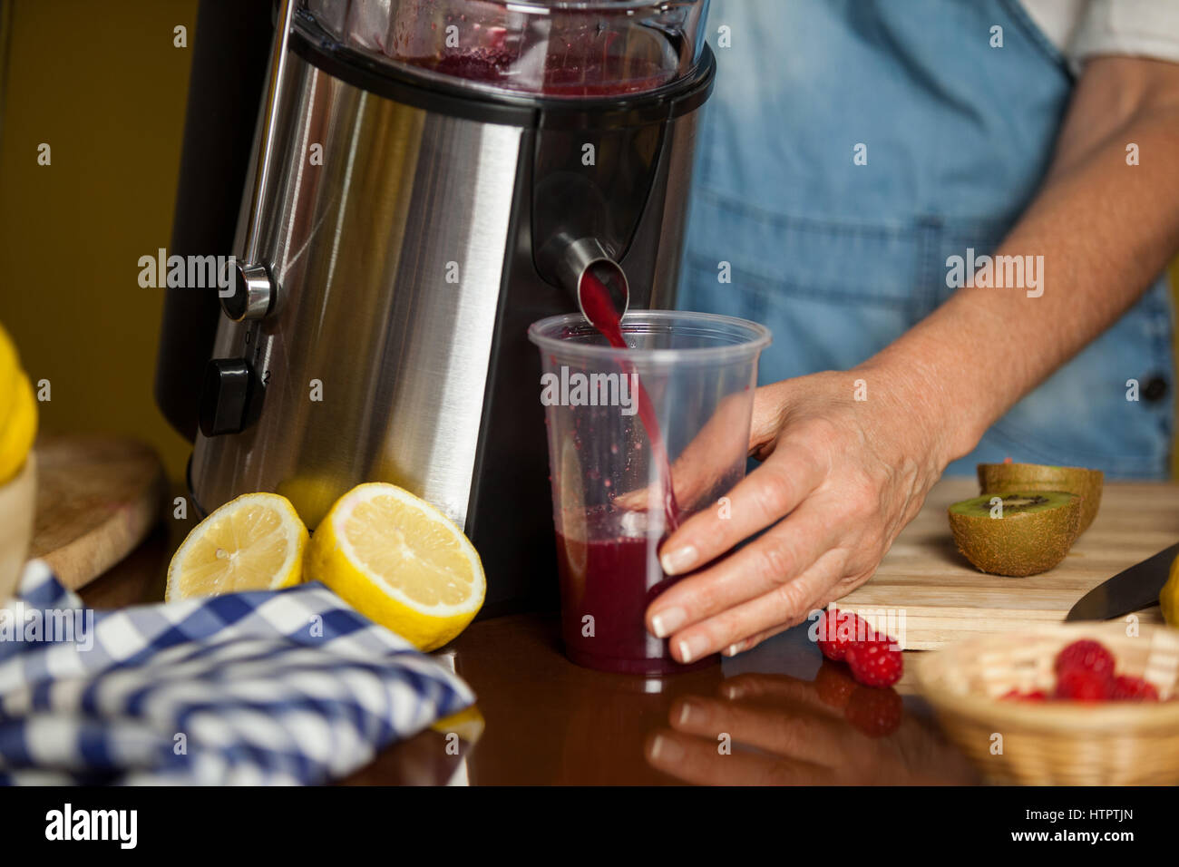 Female staff preparing a juice at health grocery shop Stock Photo - Alamy