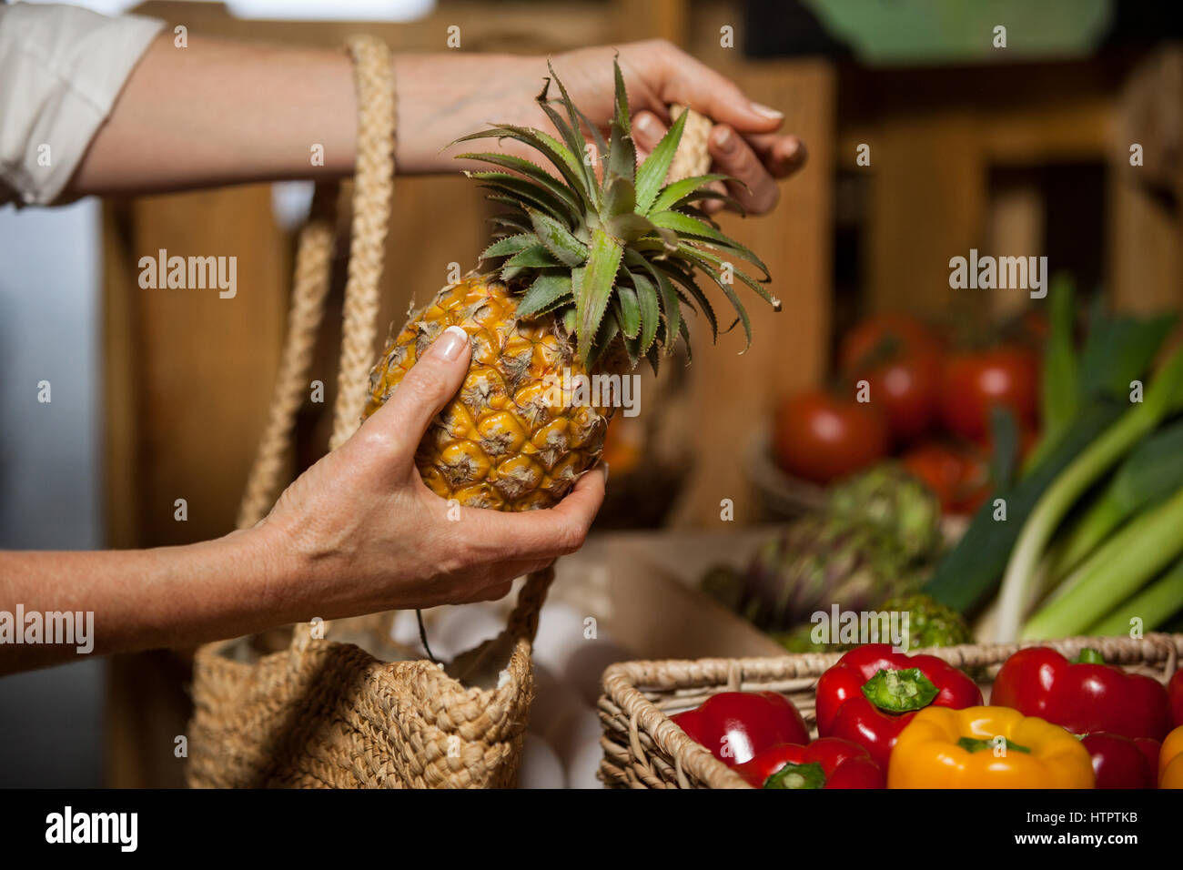 Woman buying pineapple at organic section in supermarket Stock Photo ...