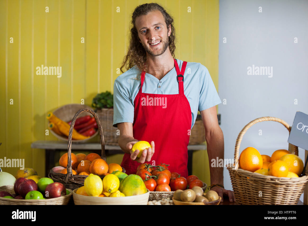Portrait of smiling staff standing at counter in market Stock Photo - Alamy