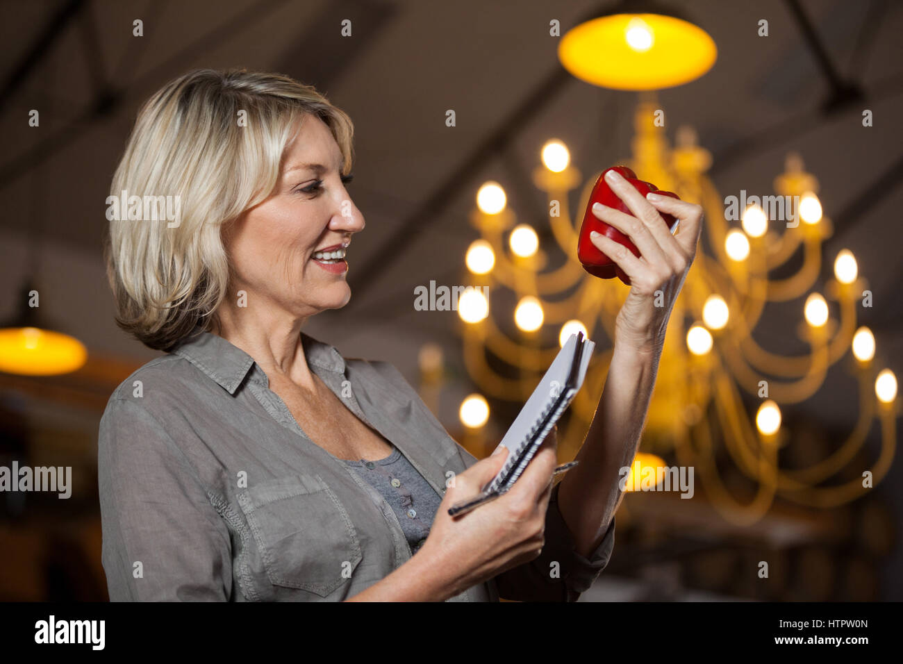 Female costumer checking bell pepper in supermarket Stock Photo - Alamy
