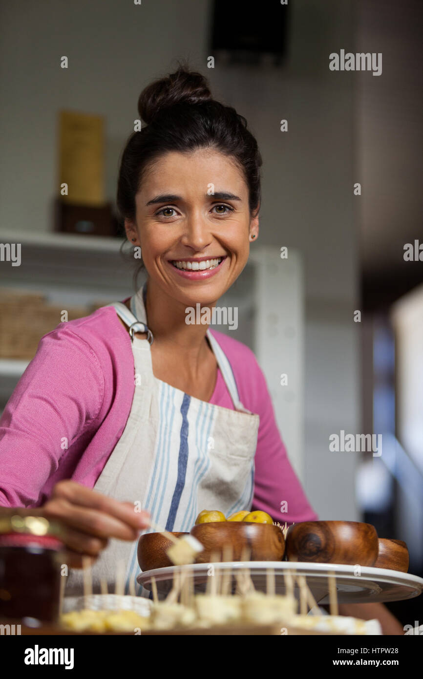Smiling female staff working at counter in market Stock Photo - Alamy