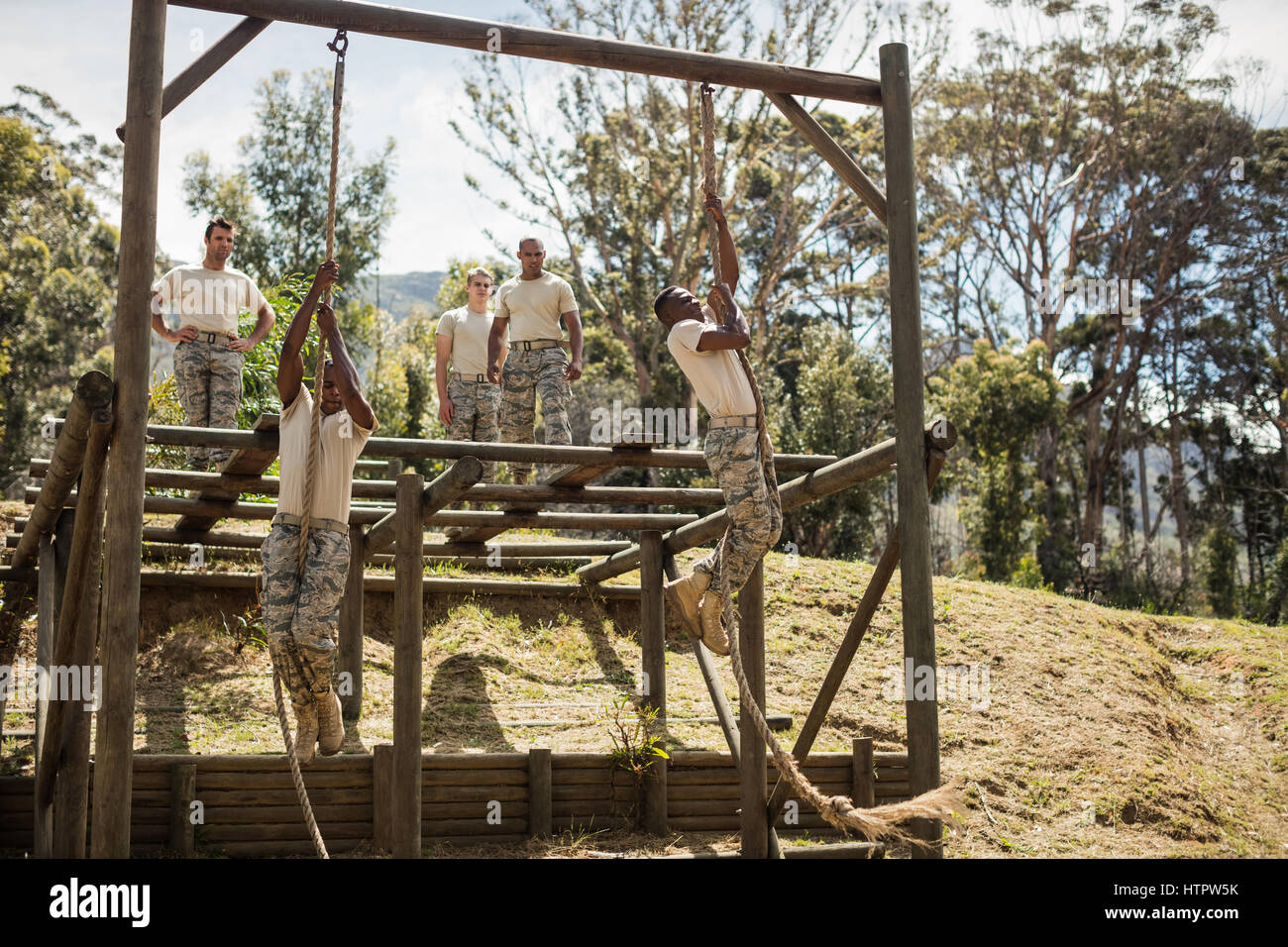 Military soldiers training rope climbing at boot camp Stock Photo - Alamy