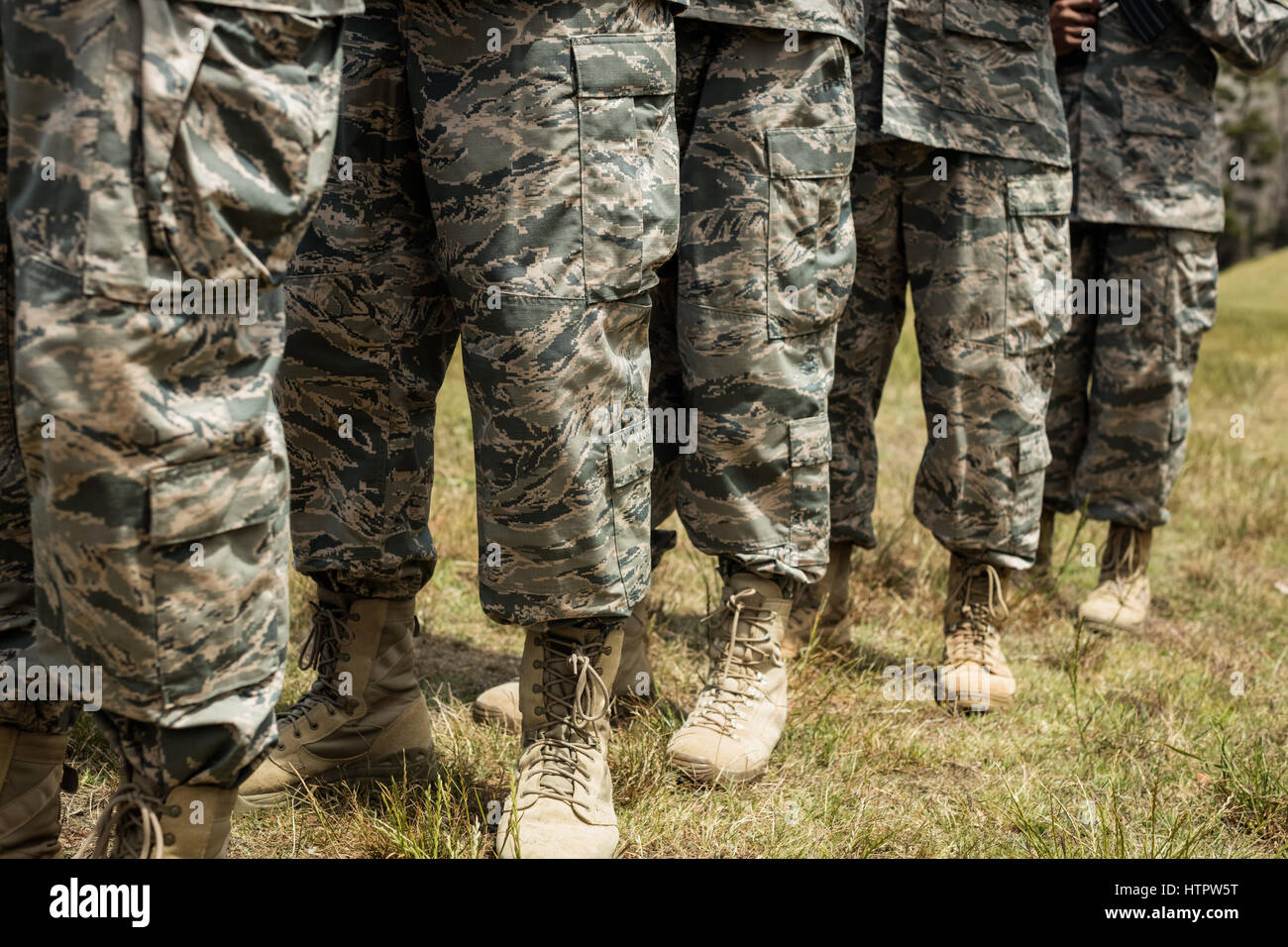 Low-section of military soldiers standing in line at boot camp Stock ...