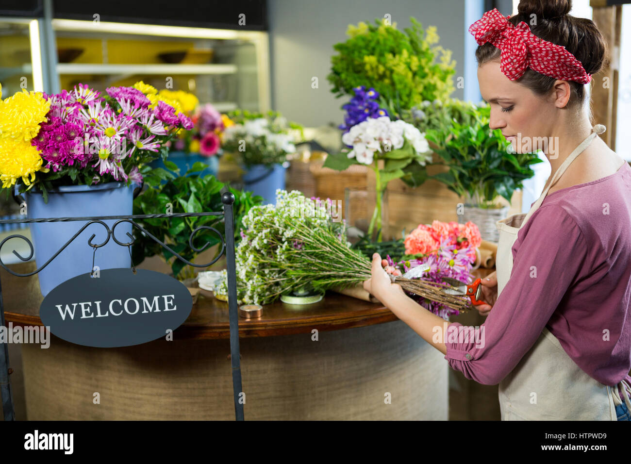 Female florist preparing flower bouquet in flower shop Stock Photo - Alamy