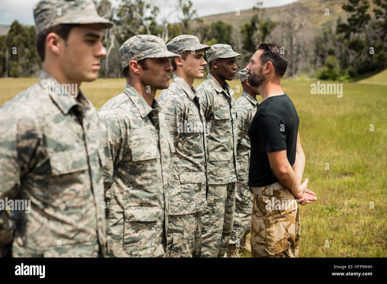 Trainer giving training to military soldier at boot camp Stock Photo ...