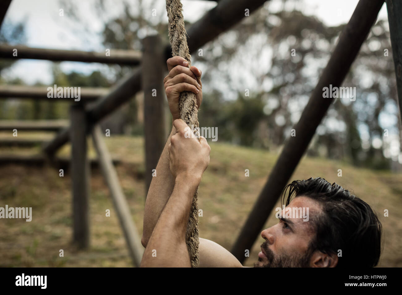 Man climbing rope during obstacle hi-res stock photography and images ...