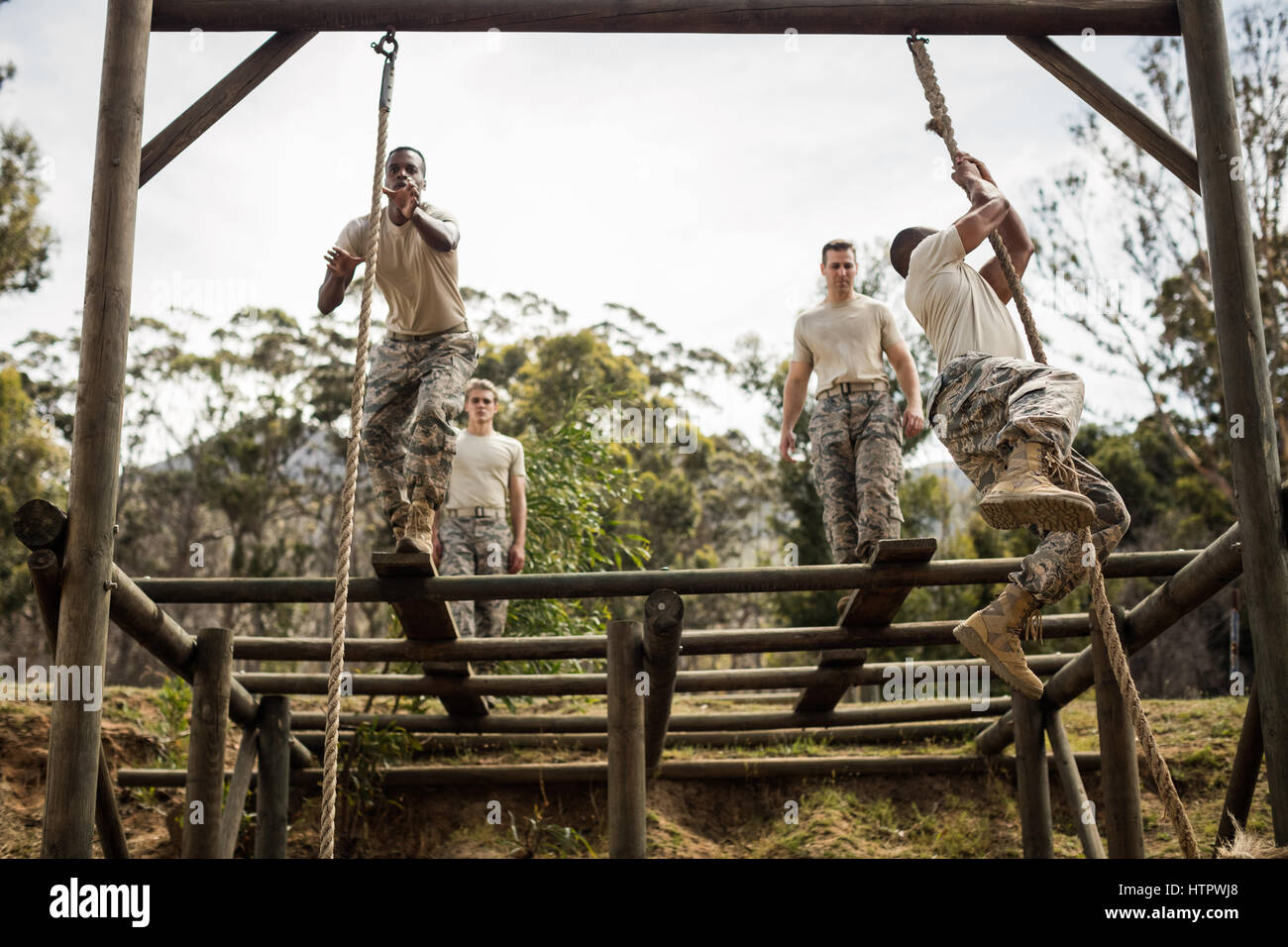 Military soldiers training rope climbing at boot camp Stock Photo - Alamy