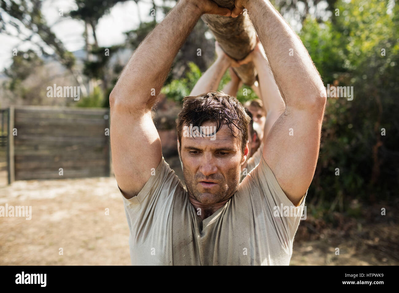 Soldiers carrying a tree log in boot camp Stock Photo - Alamy