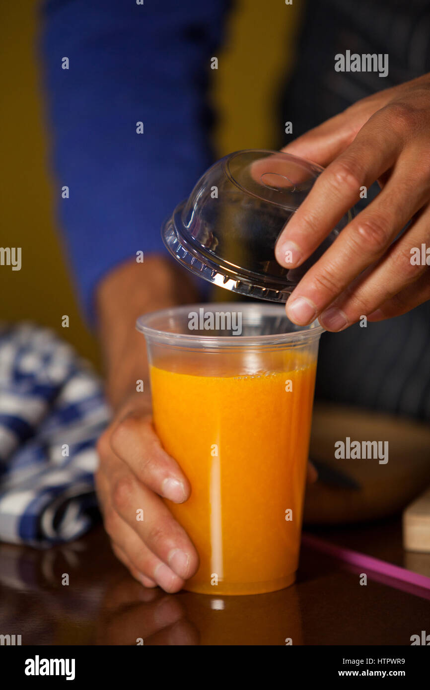 Male staff putting straw in a glass at supermarket Stock Photo - Alamy