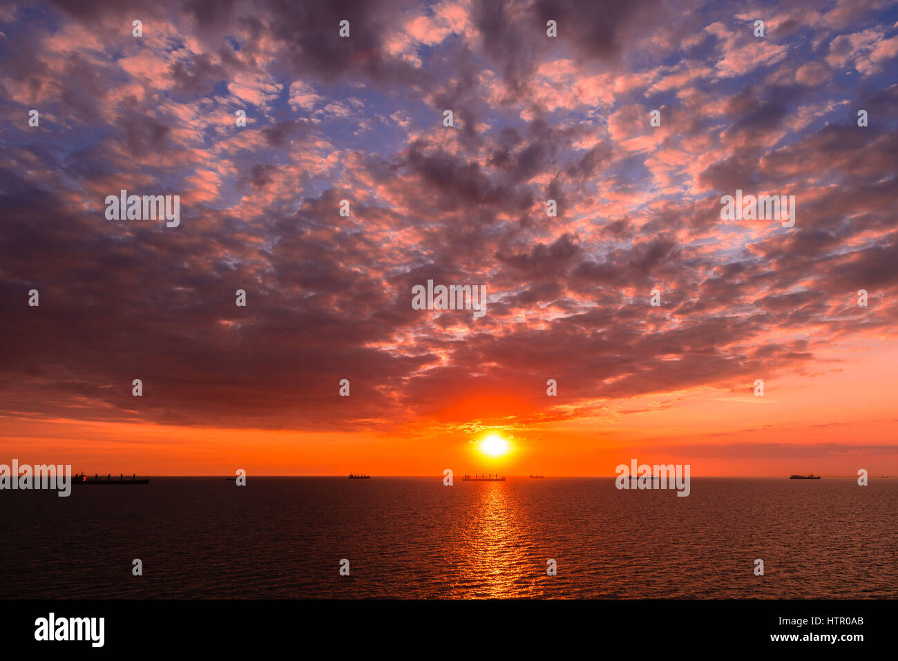 Ocean lane, colorful sunset and impressive evening clouds, Baltic Sea ...