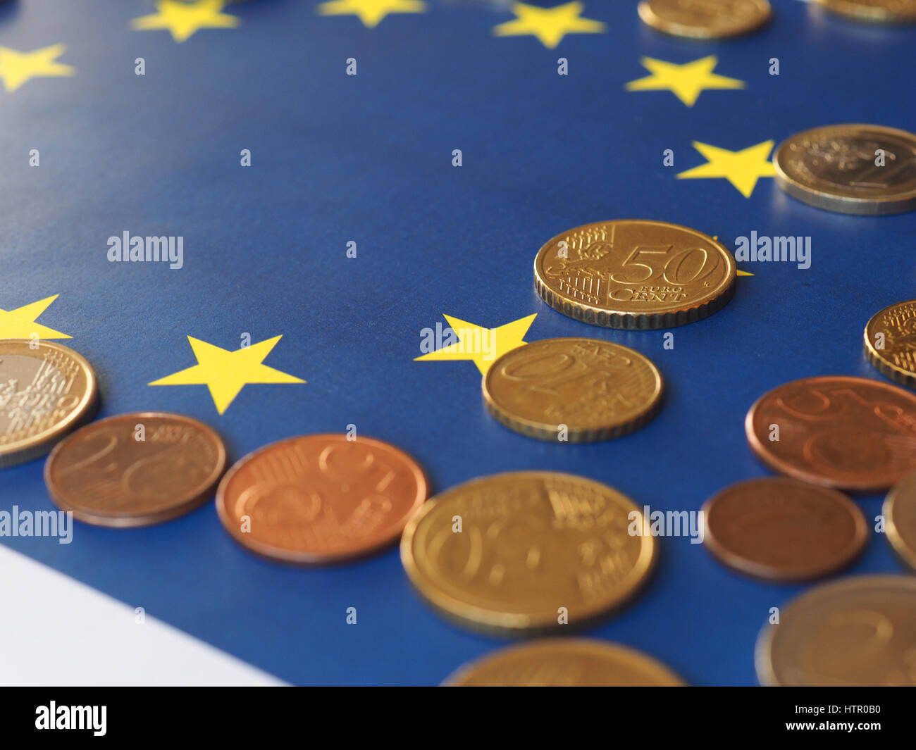Euro coins (EUR), currency of European Union over flag of Europe Stock ...