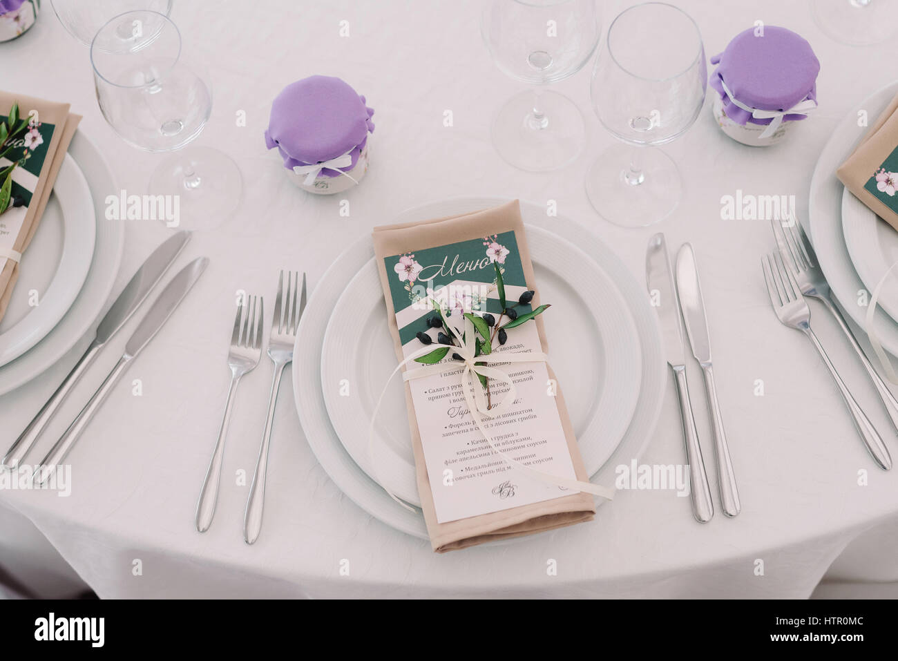 Decorated with bow menus on setting, with small bottles near them ...