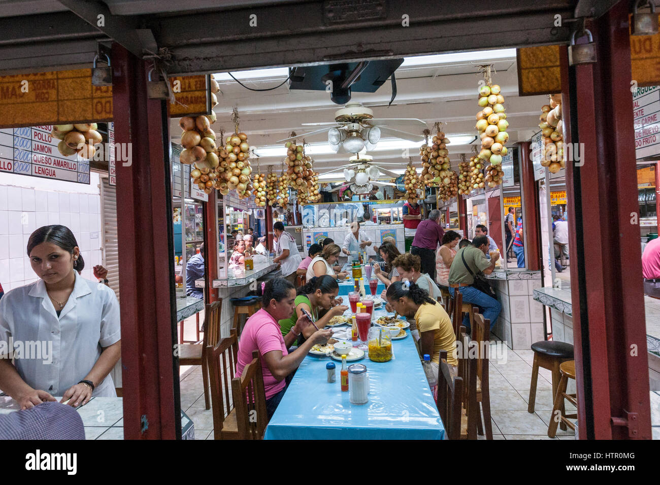 Locals eating in a market restaurant in Mercado, market, in San Jose ...