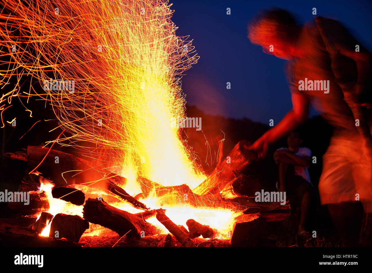 Men feeding a big campfire at Bocaina Hills, São Paulo Estate, Brazil ...