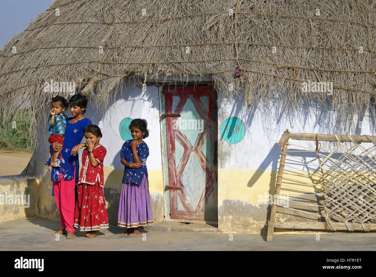 Kansi Rabari children outside their thatched and decorated home (bhunga ...