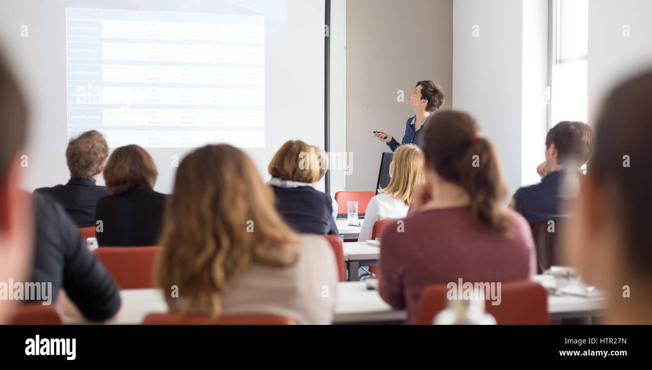 Woman giving presentation in lecture hall at university Stock Photo - Alamy