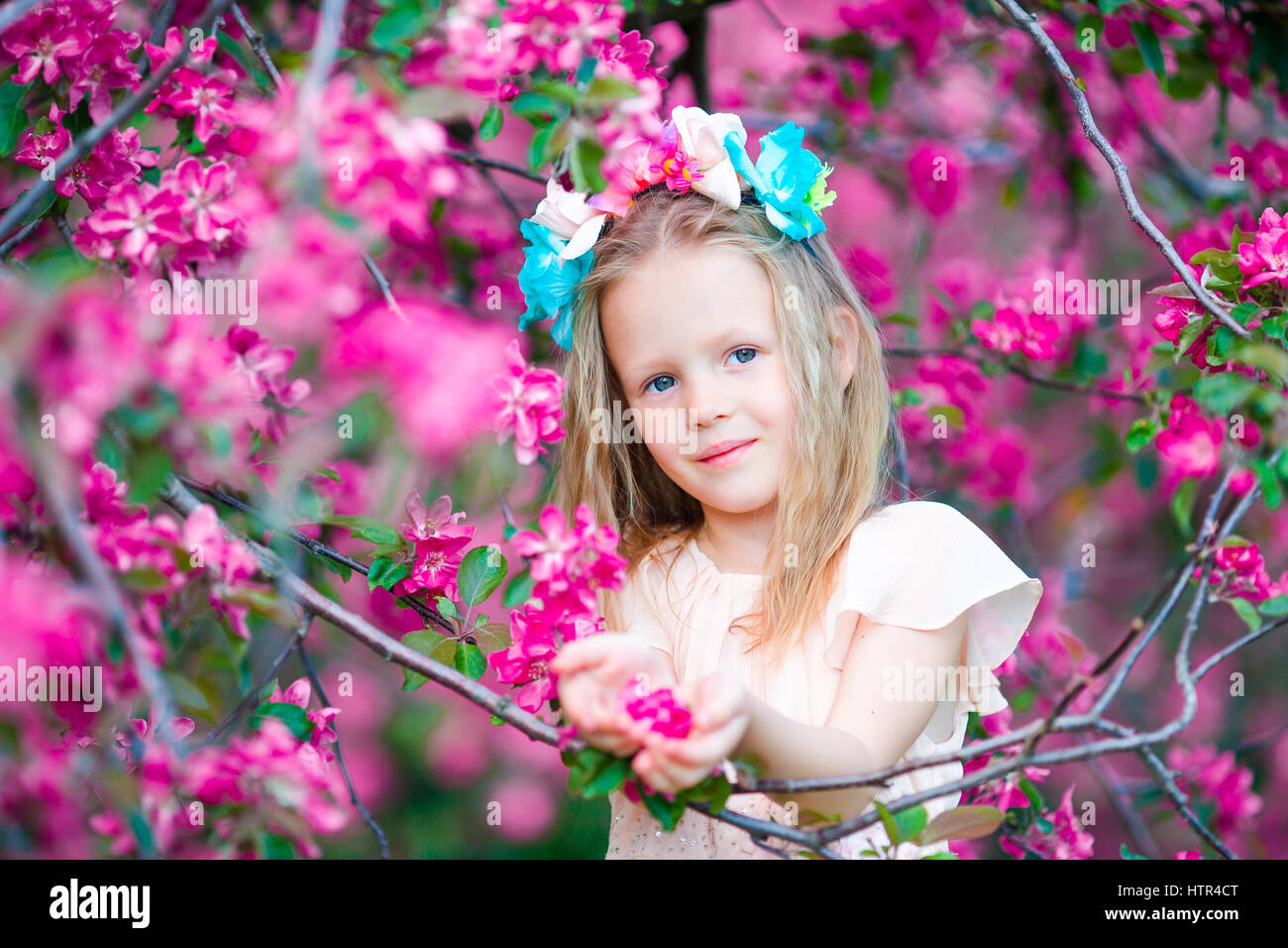 Portrait of adorable little girl in in blooming apple tree garden on spring day Stock Photo - Alamy
