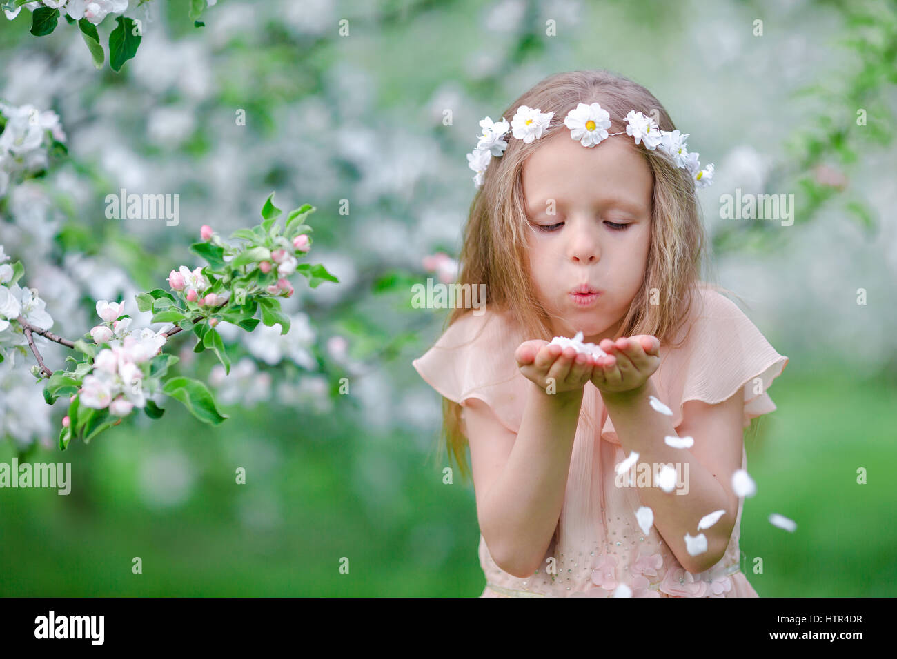 Adorable little girl in blooming tree garden on spring day Stock Photo ...