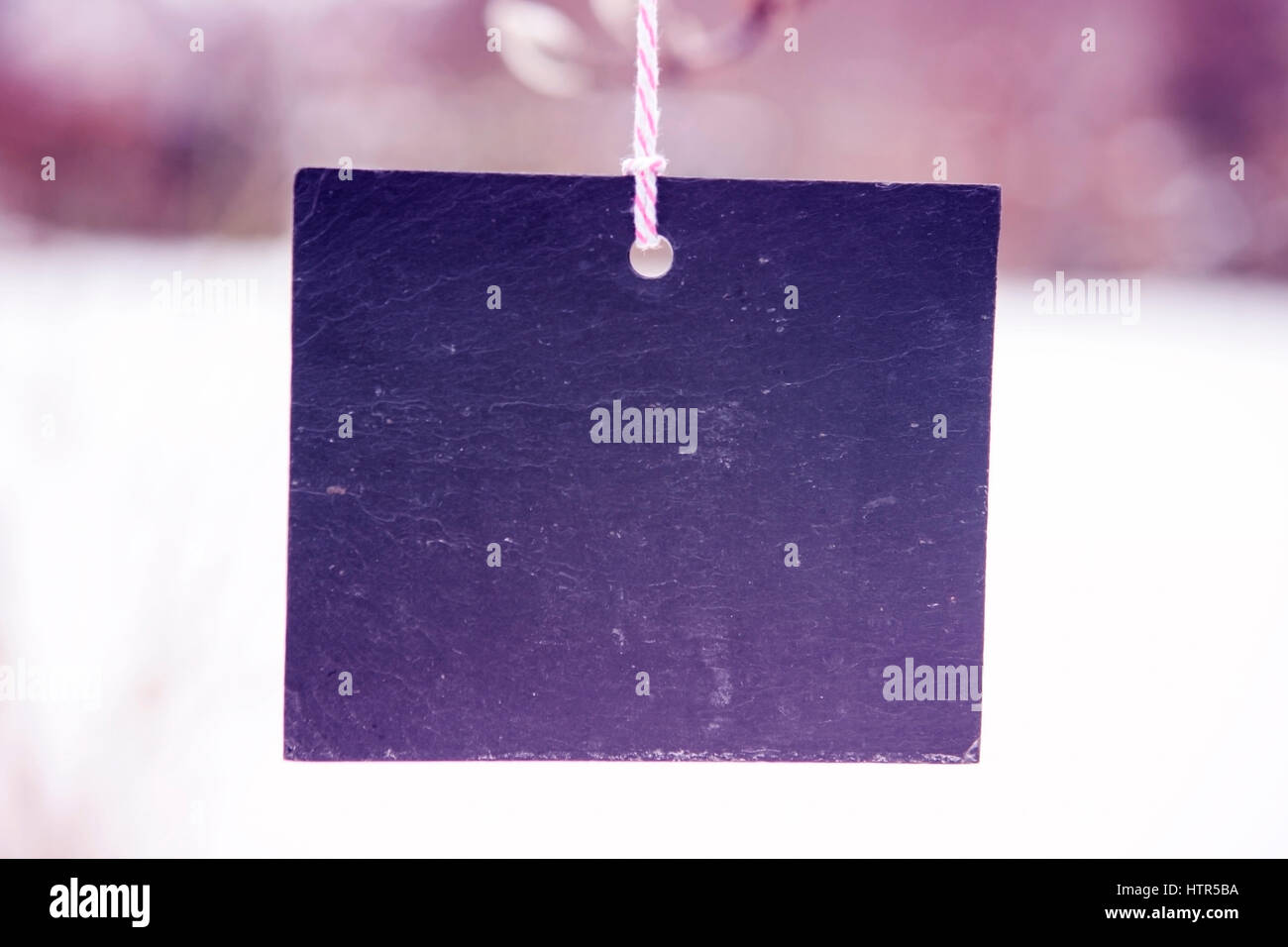 black chalkboard hanging on a string outside Stock Photo - Alamy