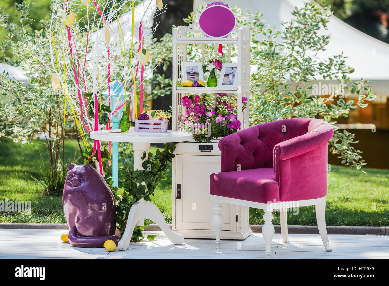 Beautiful unusual wedding decor. Photo zone with whatnot, armchair ...