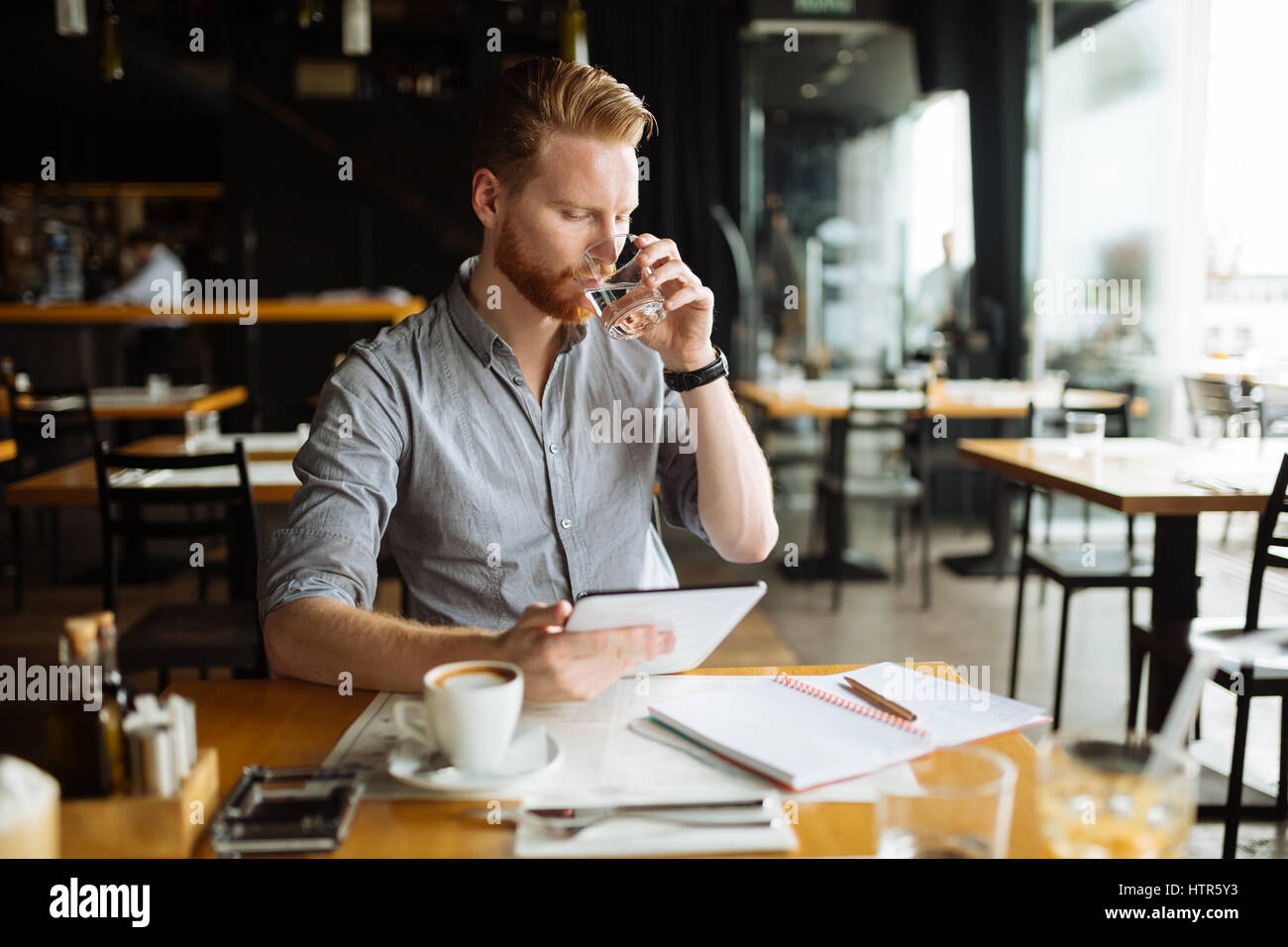 Businessman taking notes in cafe and writing down ideas Stock Photo - Alamy