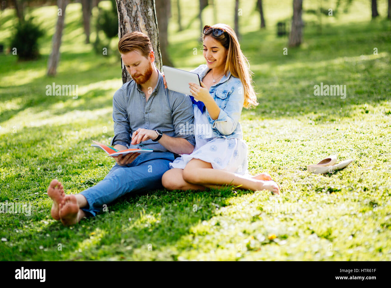 Beautiful couple studying together for exams in nature Stock Photo - Alamy