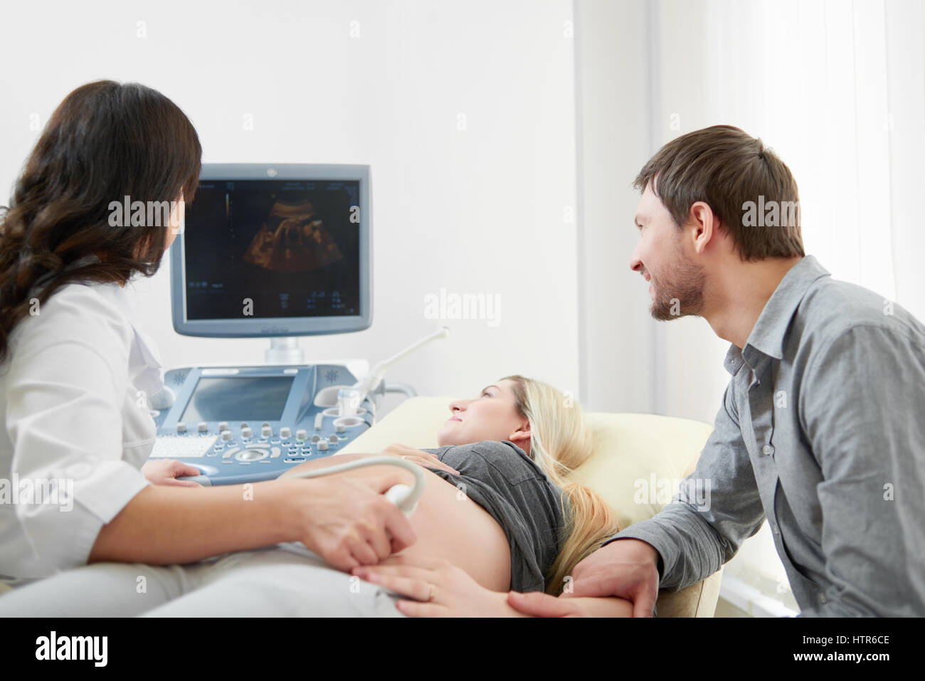 Parents expecting baby and diagnosed by ultrasound Stock Photo - Alamy