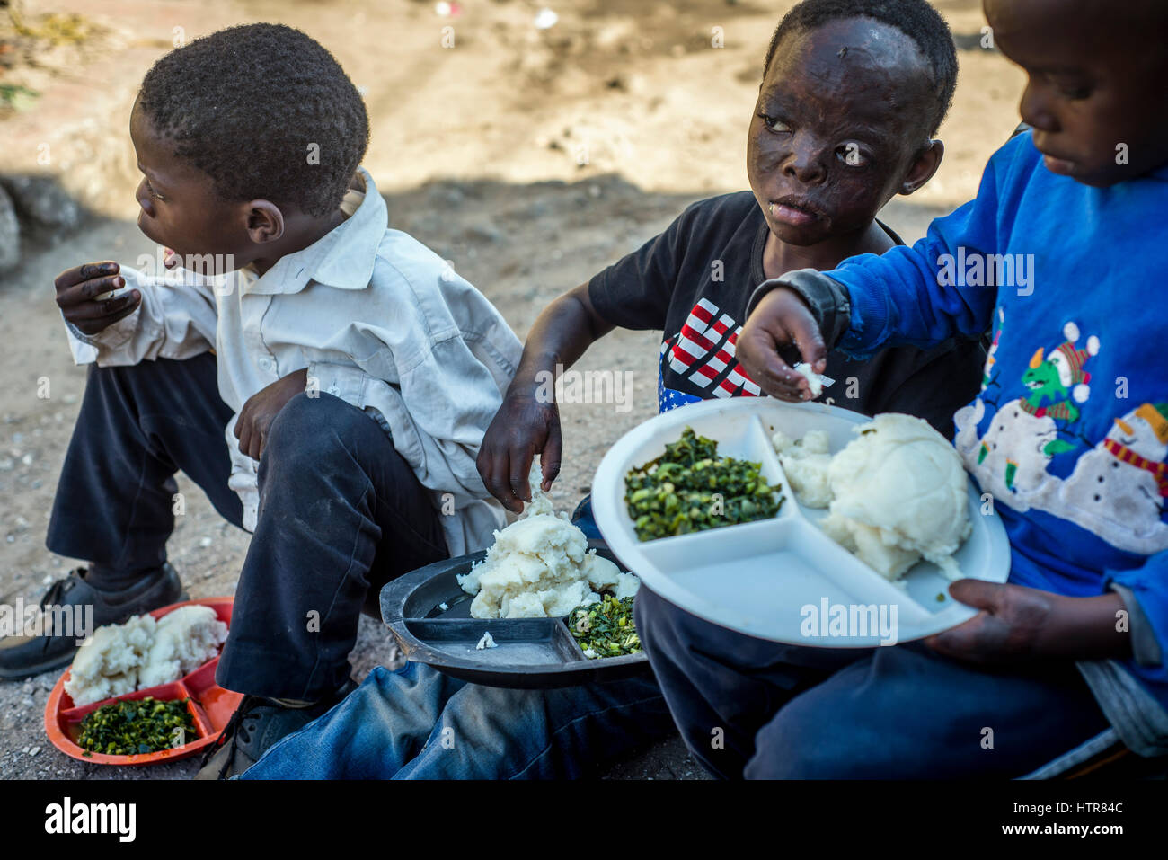 Boys eat their lunch at Home of Happiness for children with ...