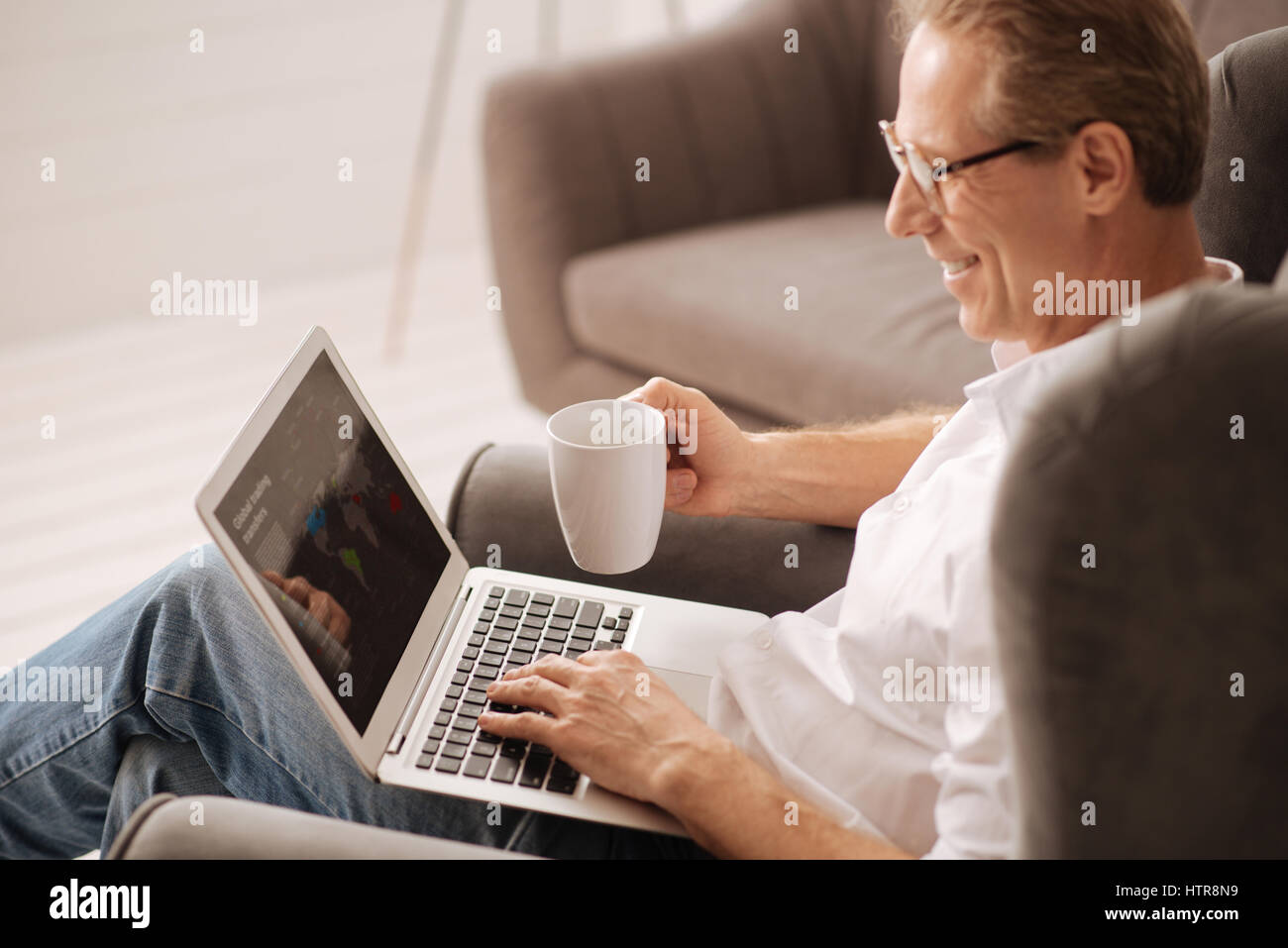 Comfortable workplace. Cheerful positive successful businessman sitting ...