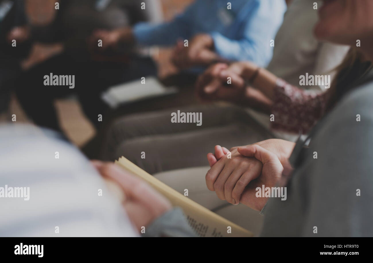 People in a counseling holding hands Stock Photo - Alamy