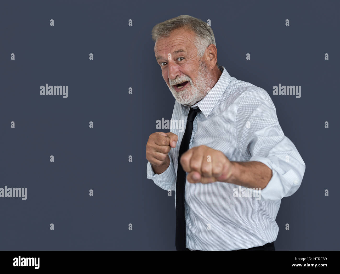 Old business man fighting hi-res stock photography and images - Alamy