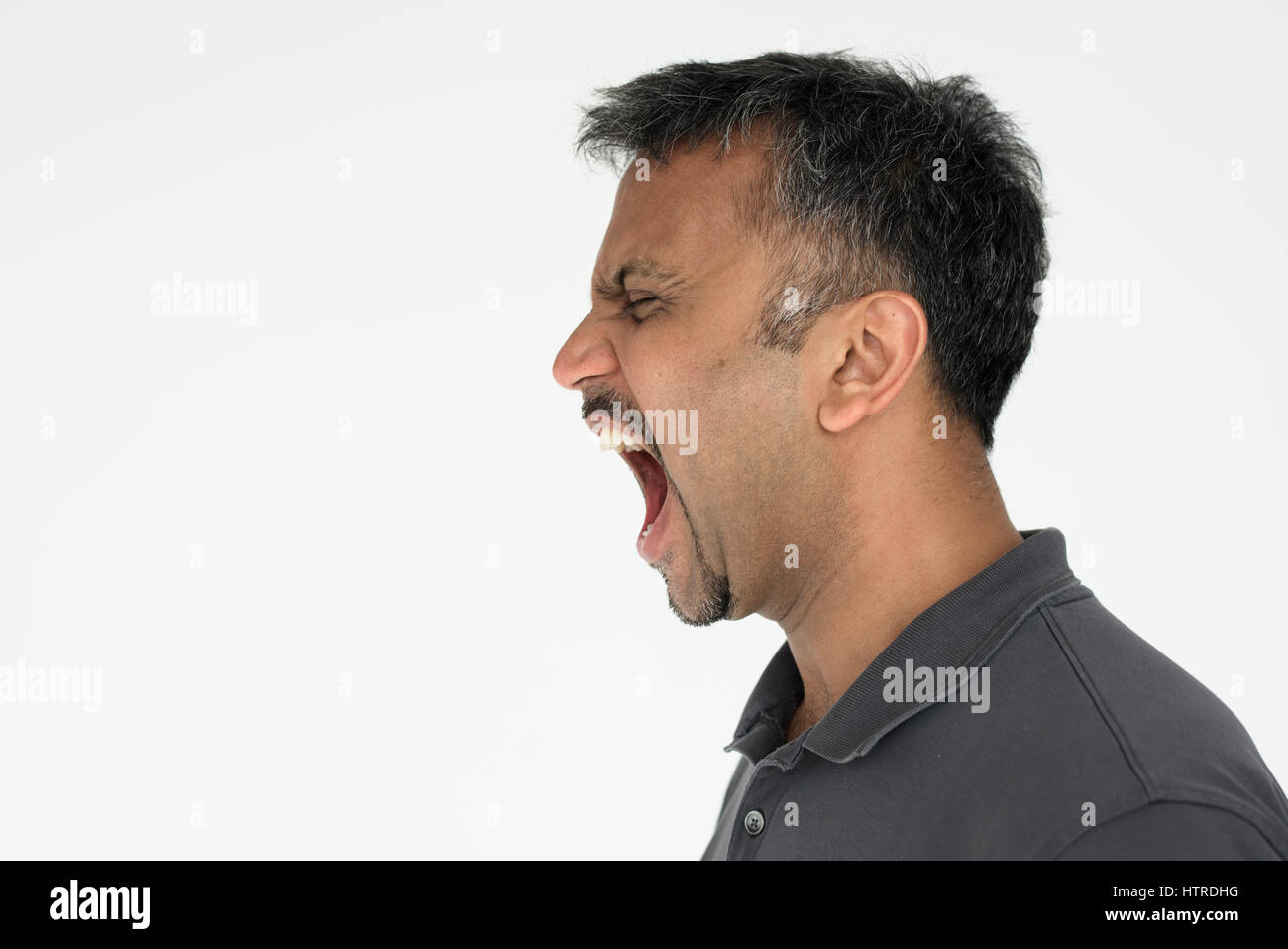 Indian guy screaming loud studio portrait Stock Photo - Alamy