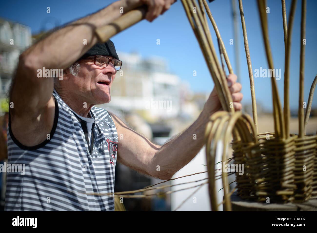 A man makes traditional cornish willow lobster pots called Withy Pots ...