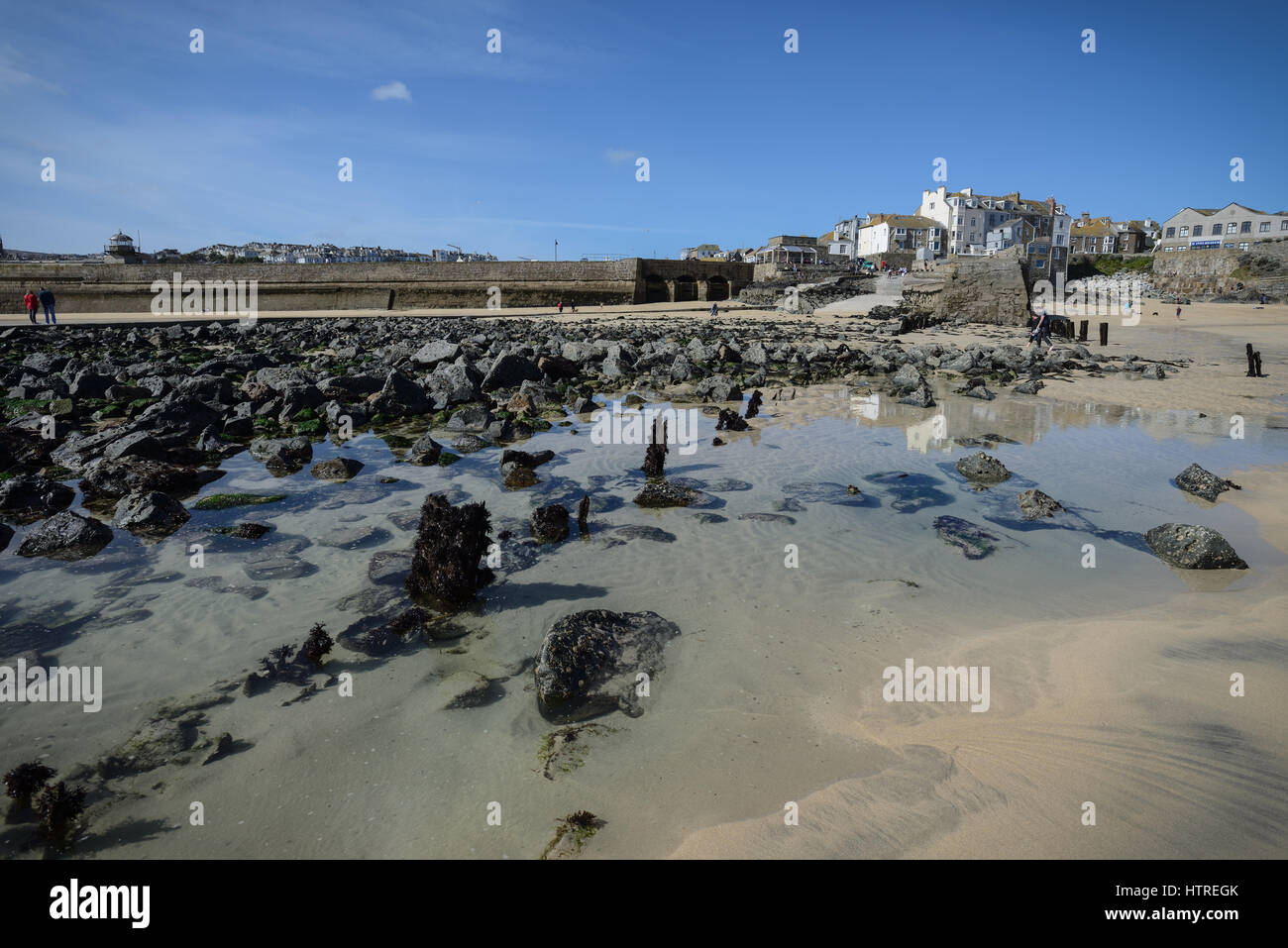Rock pools exposed on the beach during low tide at St Ives, Cornwall ...