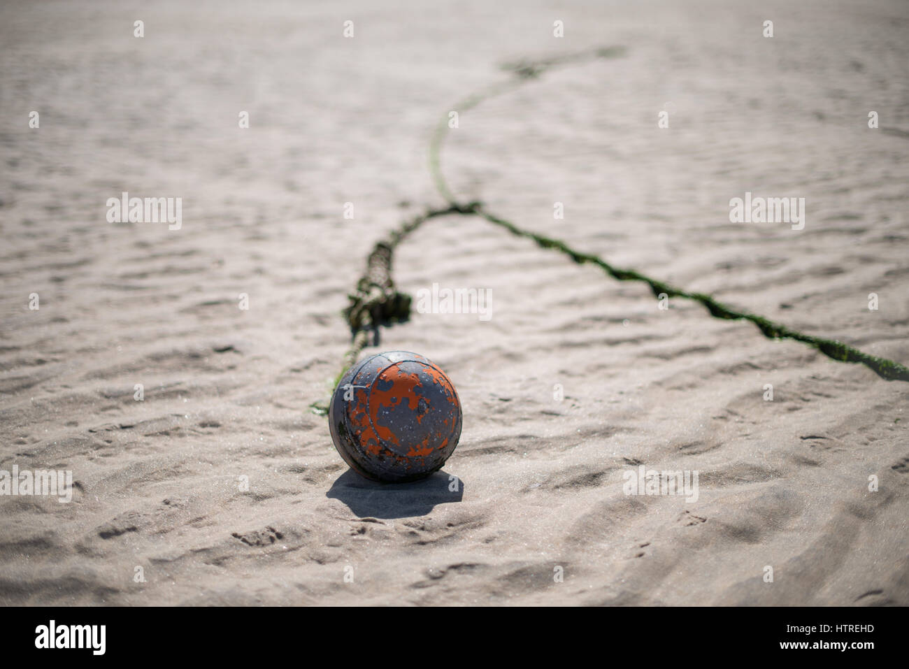Buoy tied to rope laying on the beach hi-res stock photography and ...