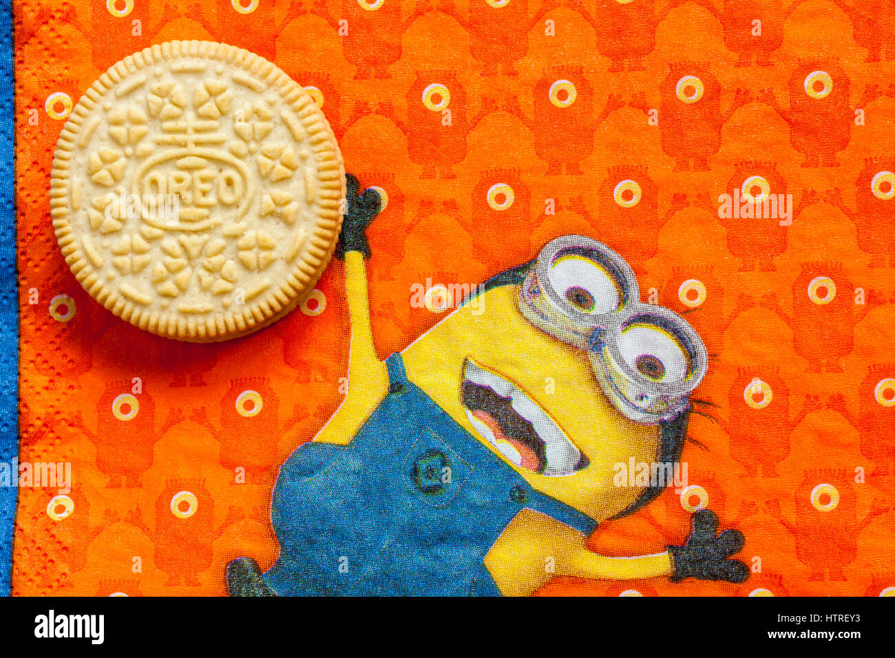 Golden Oreo biscuits on serviette with Minions - Minion juggling with ...