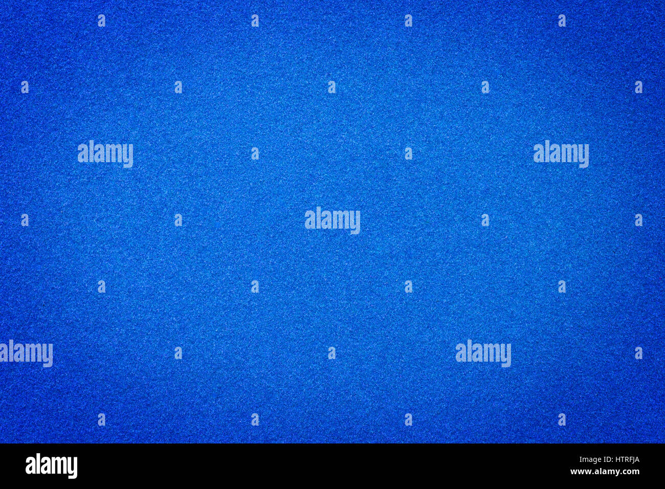 Blue velvet textured paper close up, light center for copy space ...