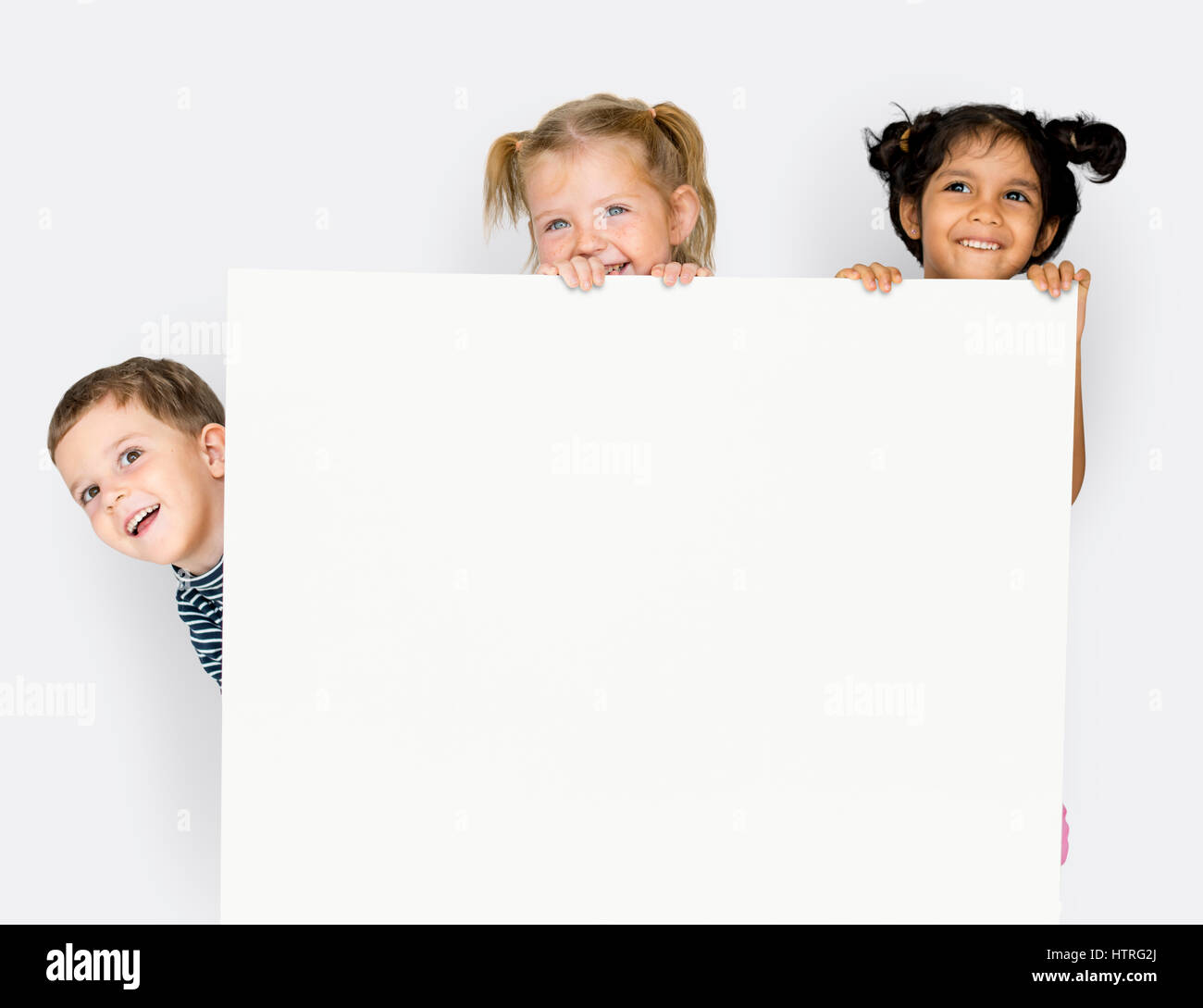 Little Children Holding Empty Paper Smiling Stock Photo - Alamy