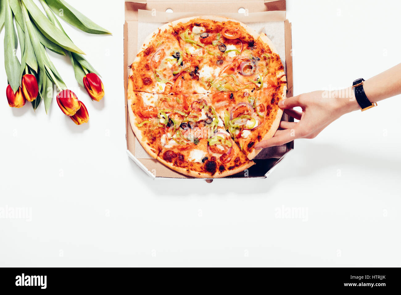 Woman's hand takes a piece of pizza out of the box, top view Stock ...