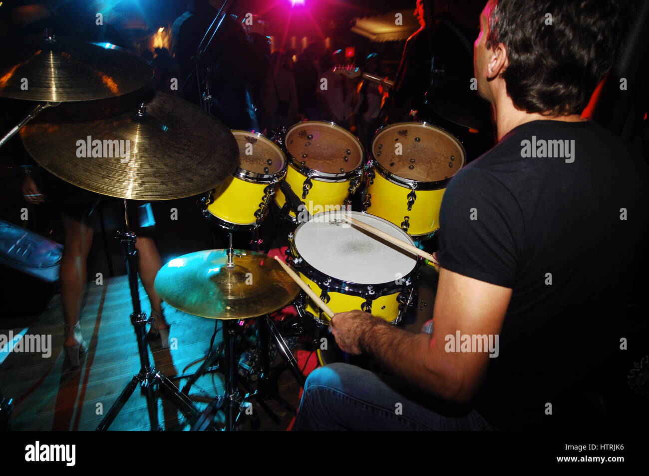 Drummer performing on stage at concert Stock Photo - Alamy