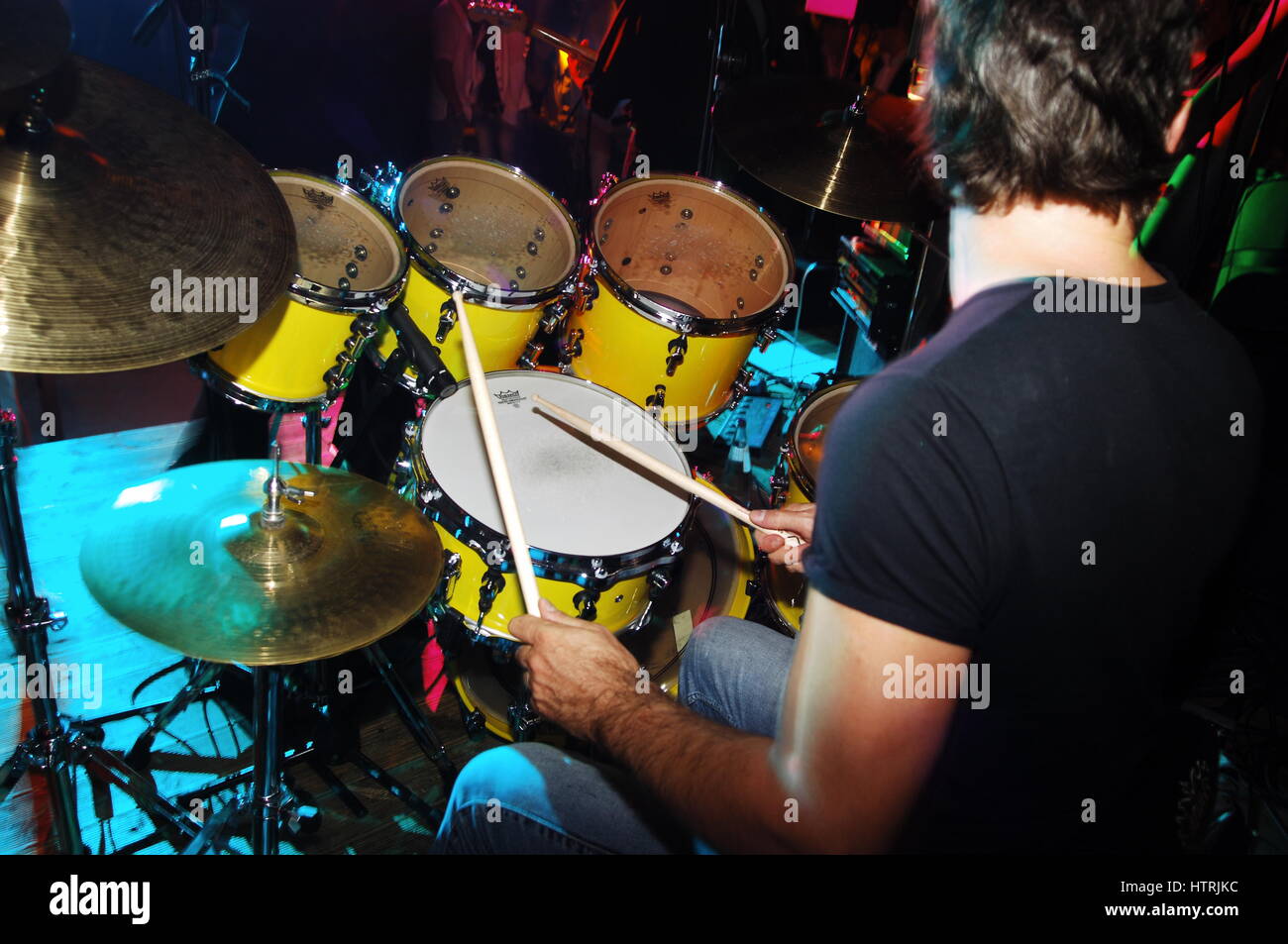 Drummer performing on stage at concert Stock Photo - Alamy